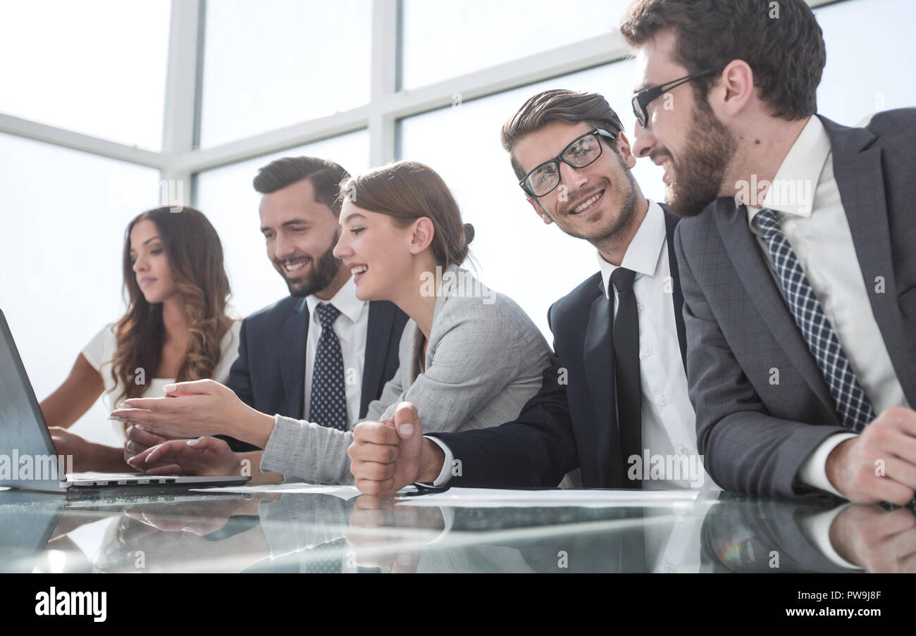 business team sitting at the office Desk in the office Stock Photo - Alamy