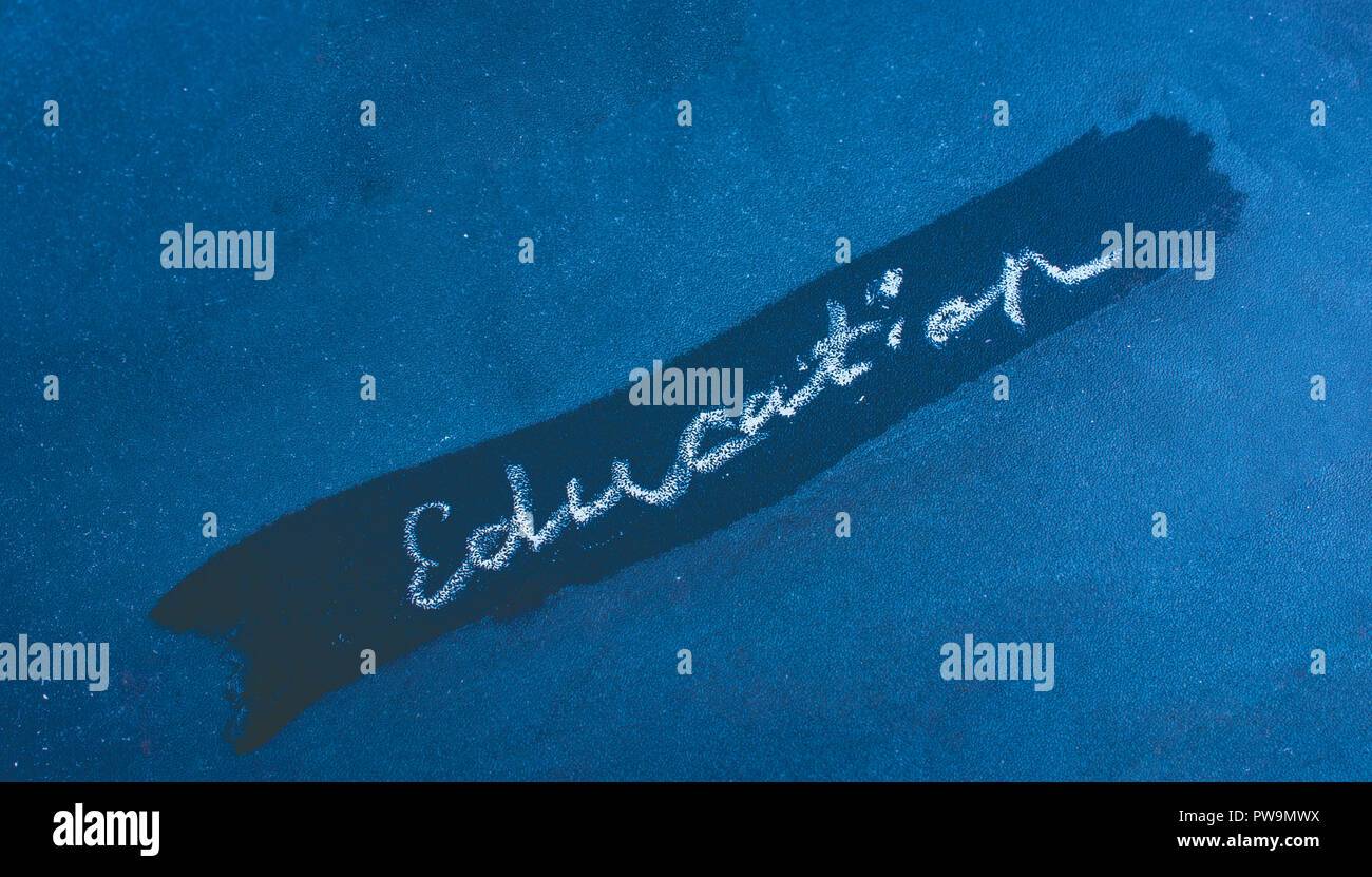 Hand written word EDUCATION with white chalk on black board Stock Photo ...