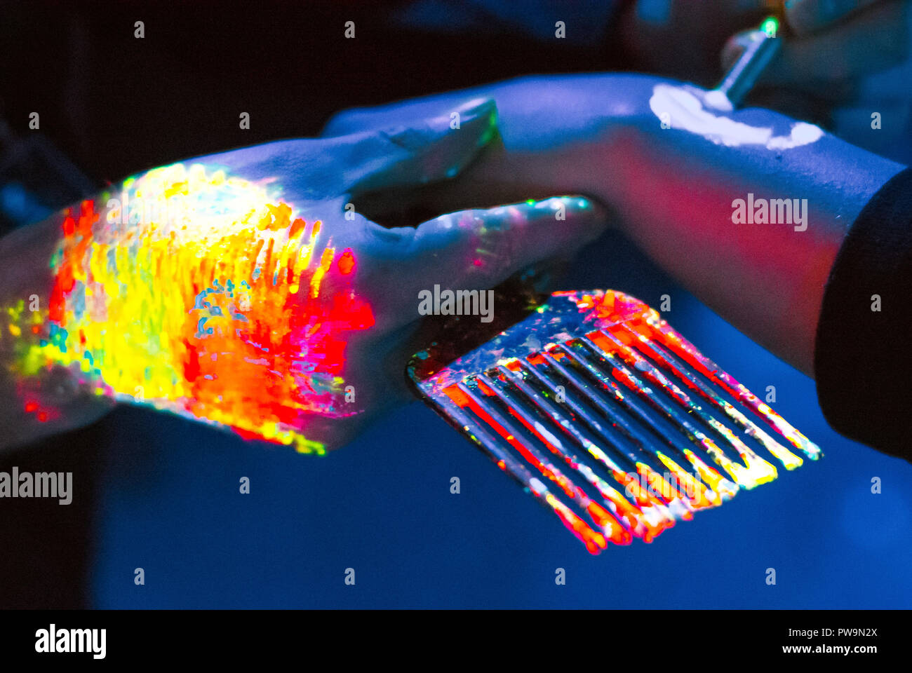 UV lights hands paint color Stock Photo - Alamy