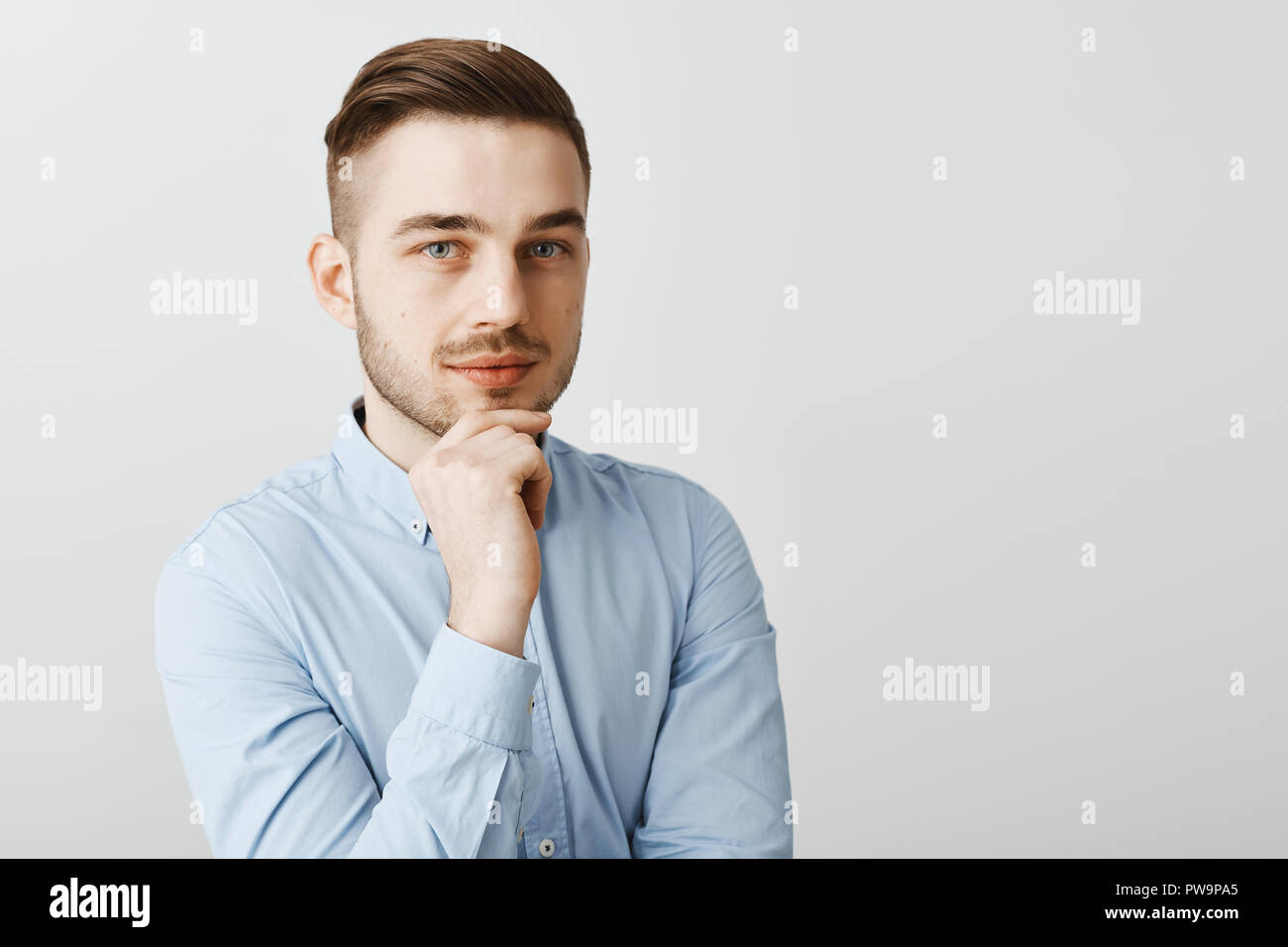 Waist-up shot of smart creative male boss in formal blue shirt being ...