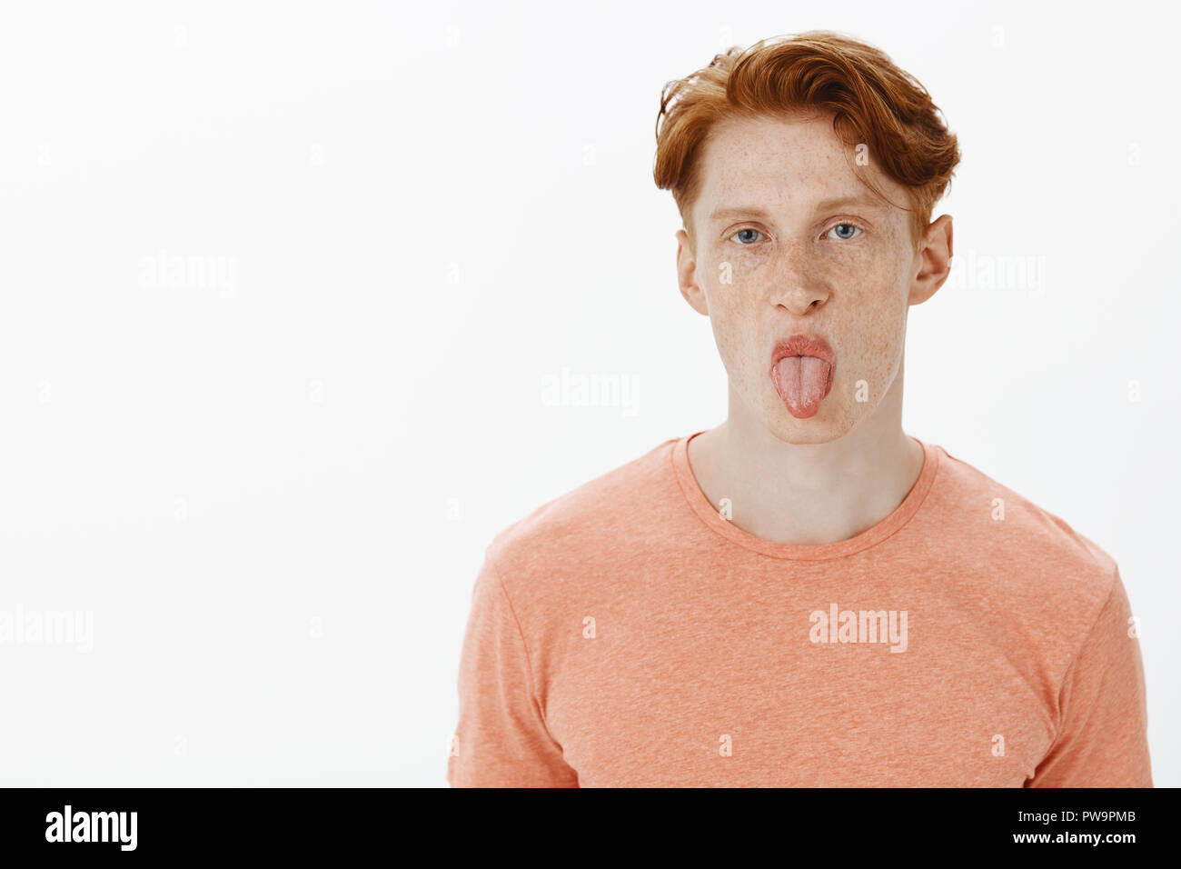 Immature funny european ginger man with freckles being childish ...