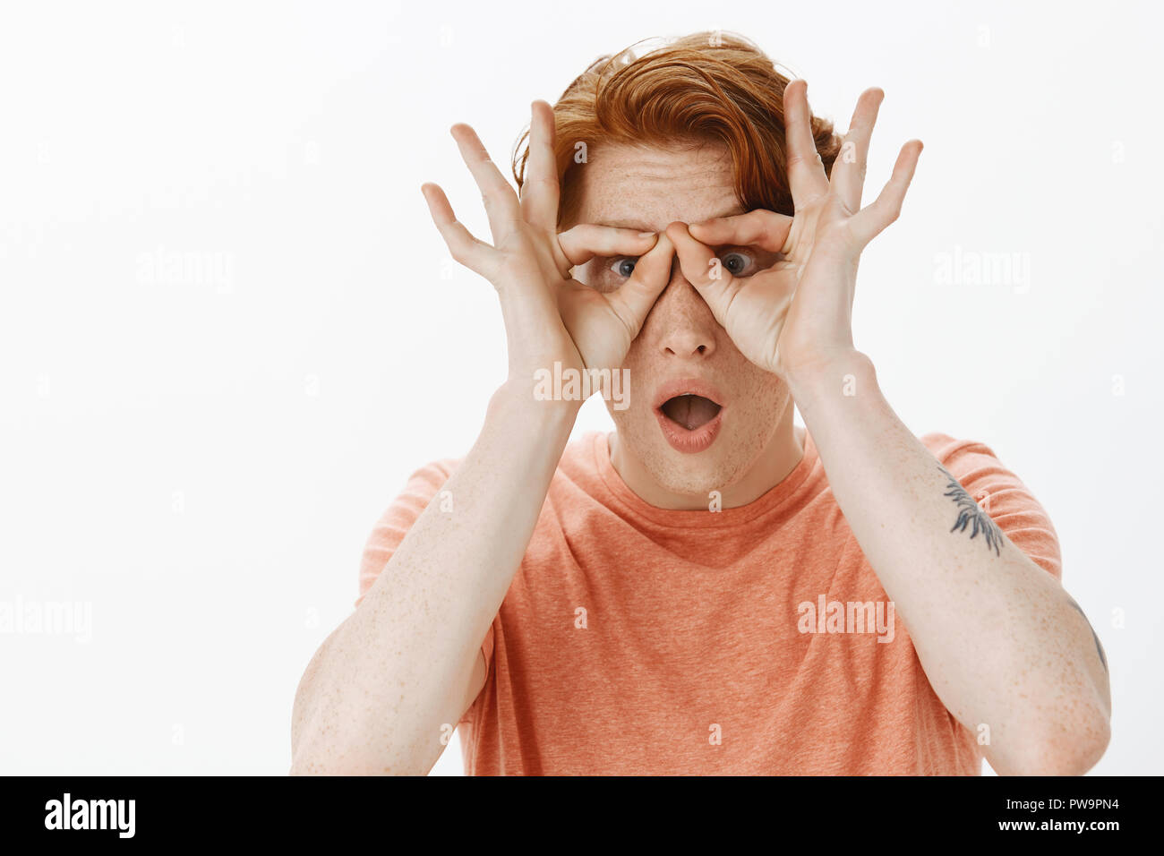 Portrait of charming carefree and childish redhead male with freckles ...