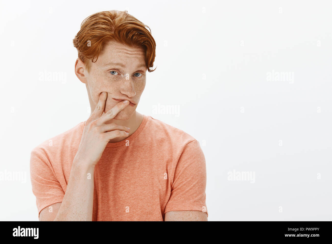 Studio shot of cute caucasian redhead with freckles and stylish ...