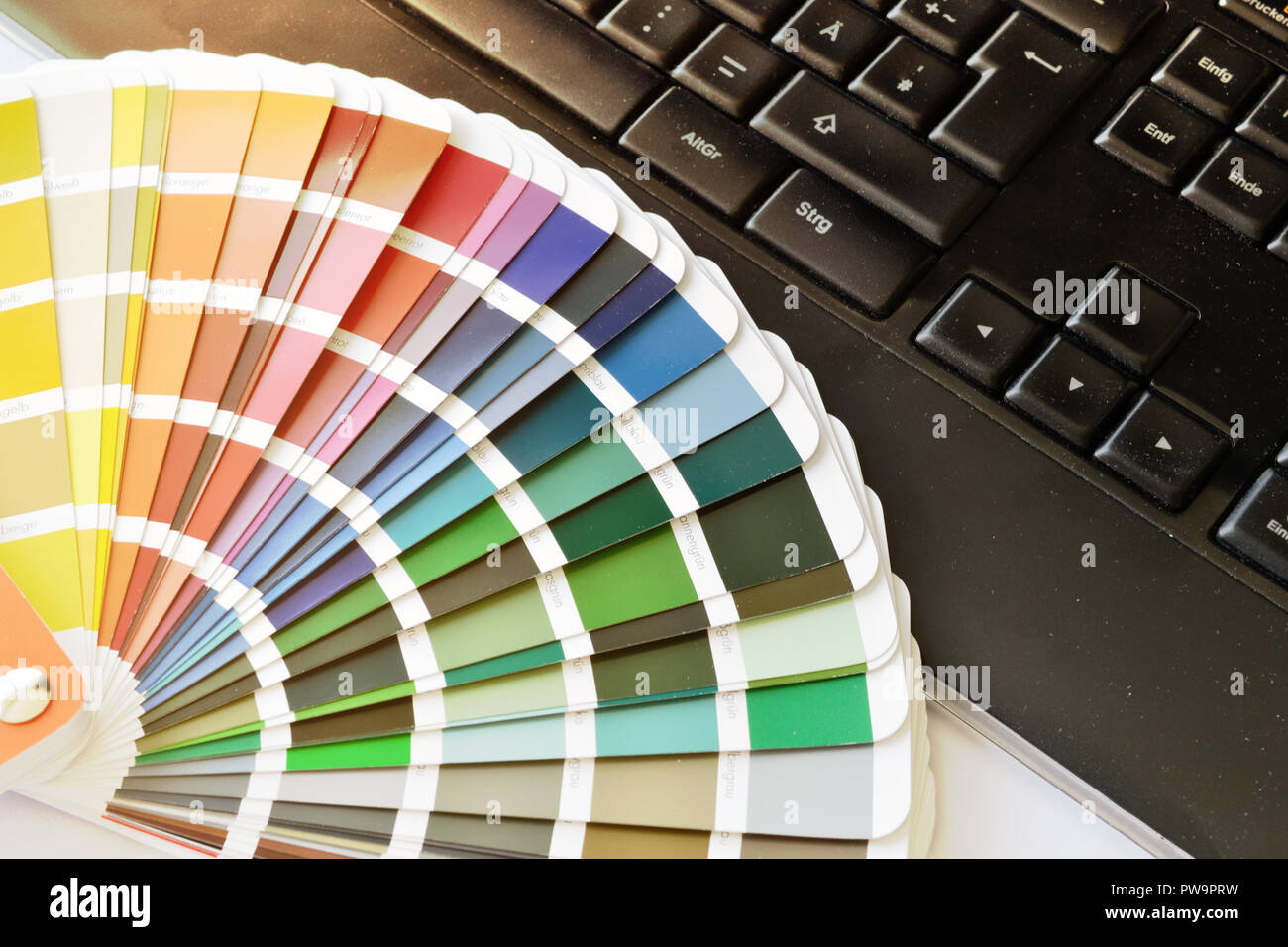 open color fan on computer keyboard Living room design Stock Photo - Alamy