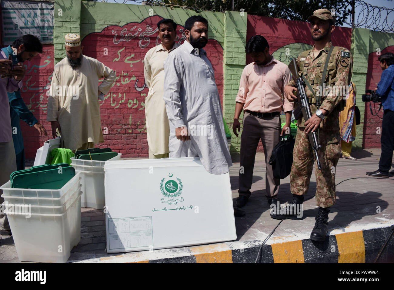 Election Commission of Pakistan's (ECP) staff is bringing ballot boxes ...