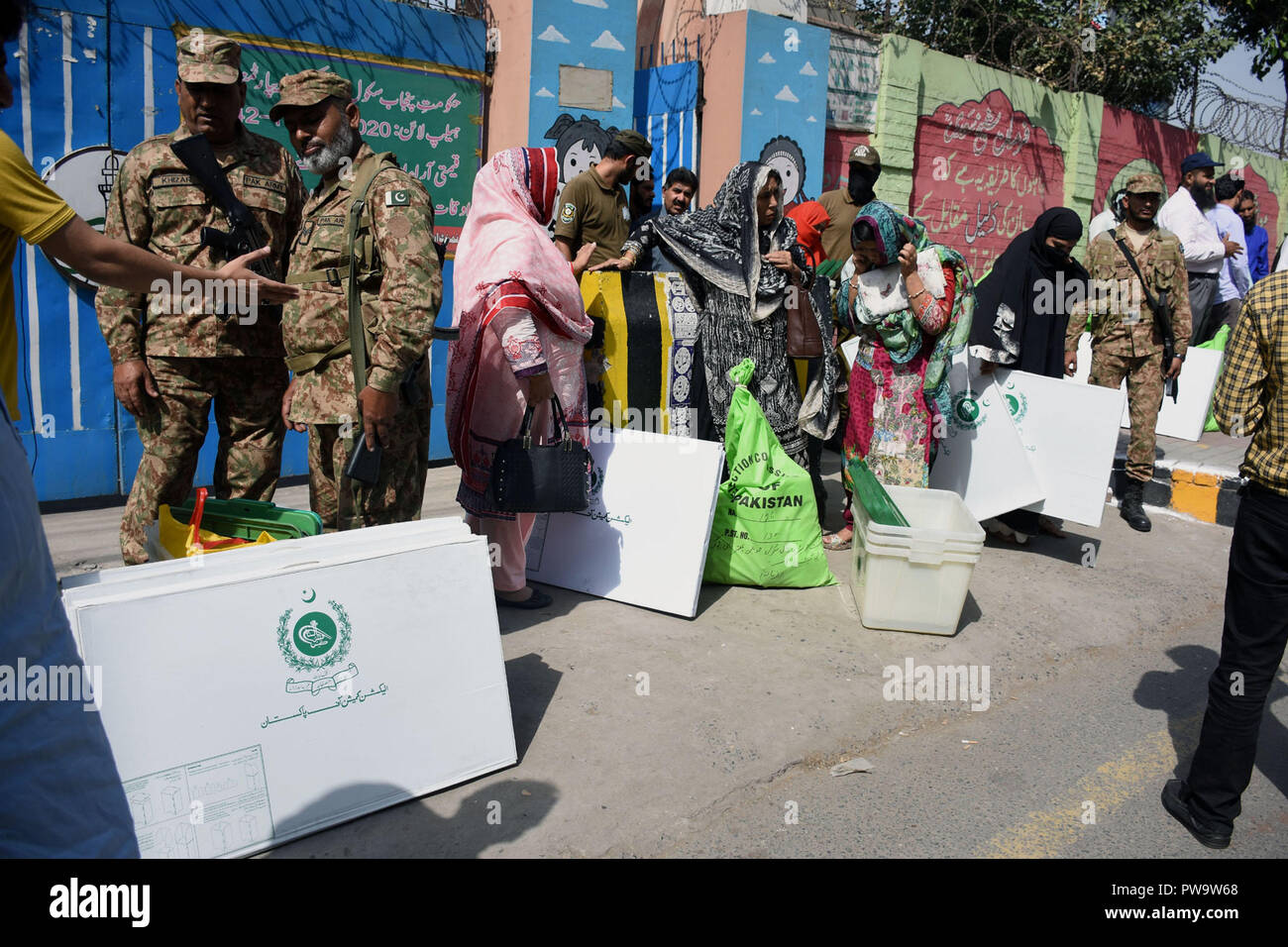 Election Commission of Pakistan's (ECP) staff is bringing ballot boxes ...