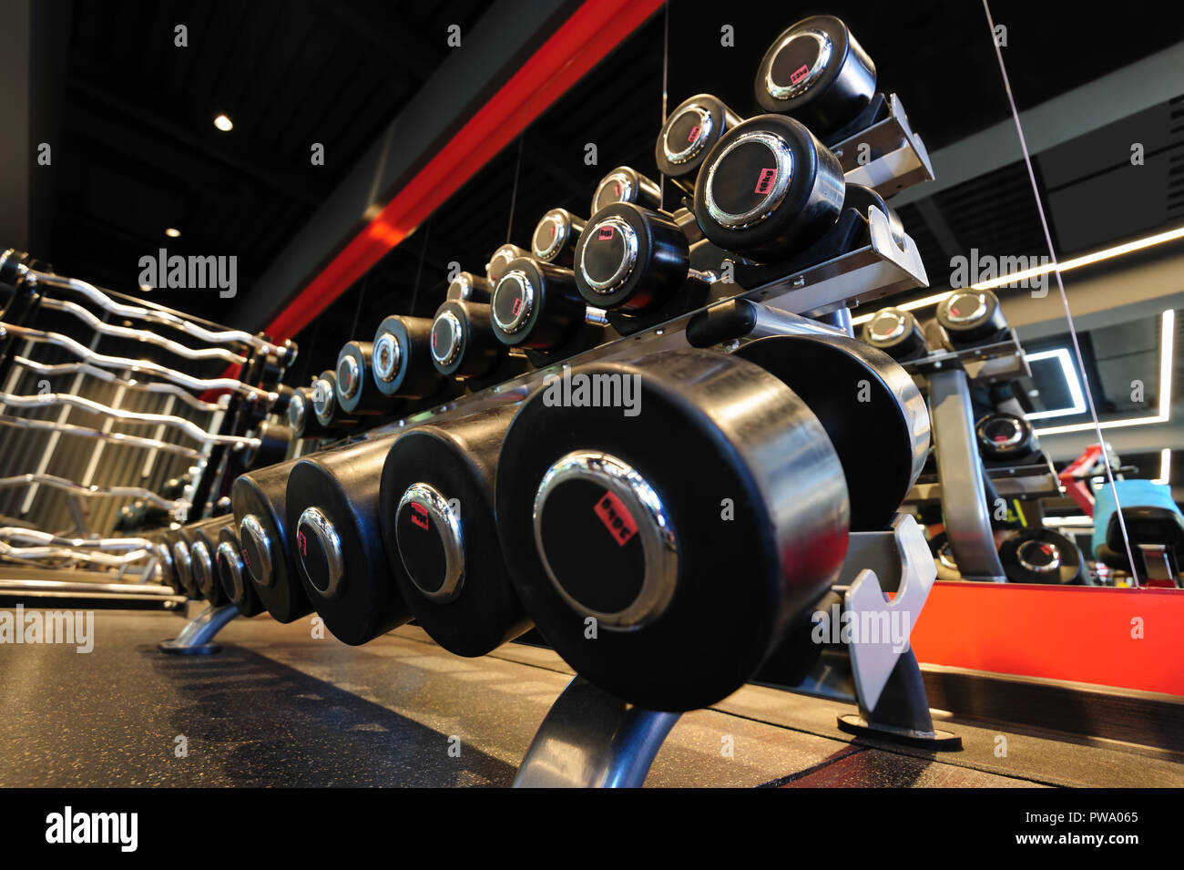 Gym interior with dumbbells stand Stock Photo - Alamy