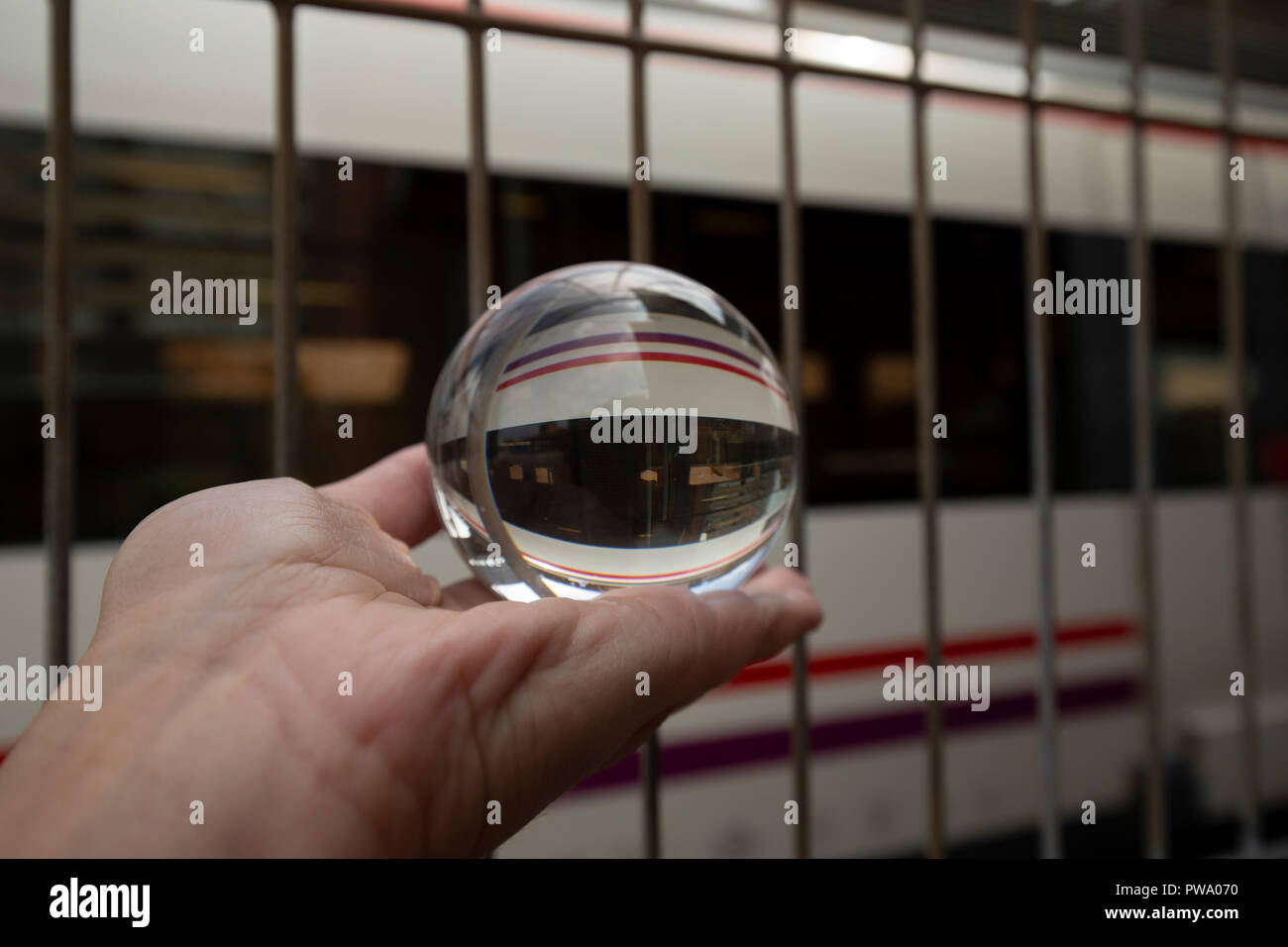 Train is reflected over a glass ball Stock Photo - Alamy