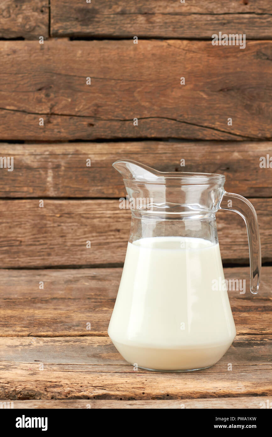 Organic milk in glass jug. Natural cow milk in glass pitcher on rustic ...