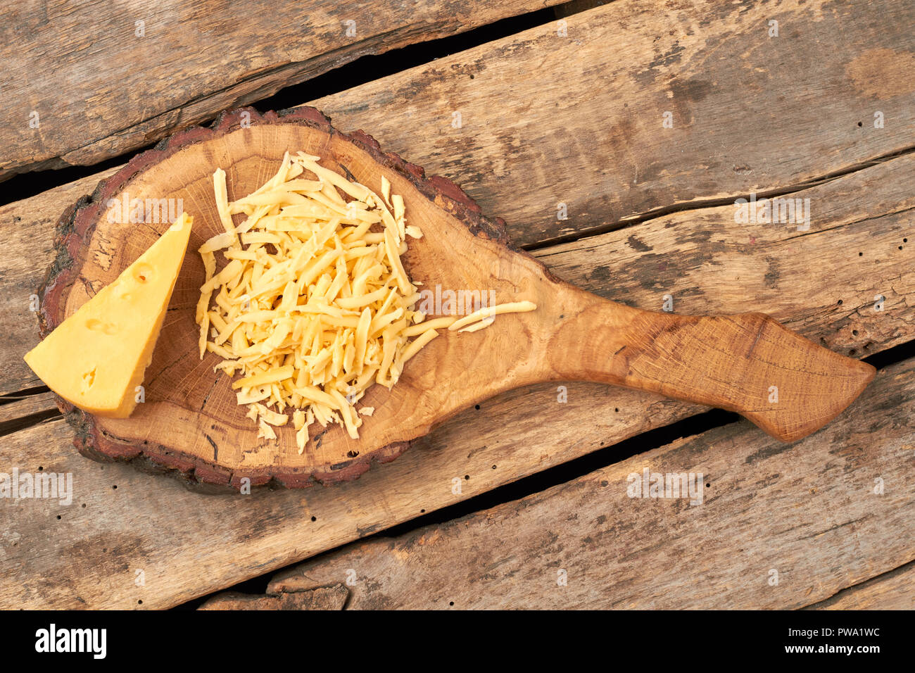 Cheese on natural wooden board. Rustic wood cheese board on grunge ...