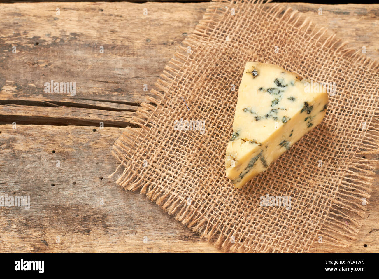 Piece of French Roquefort cheese on rustic background. Blue cheese on ...
