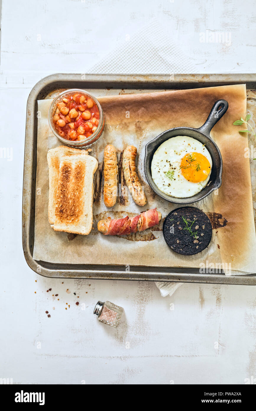 Full english fry up breakfast with egg, sausages, black pudding, baked ...