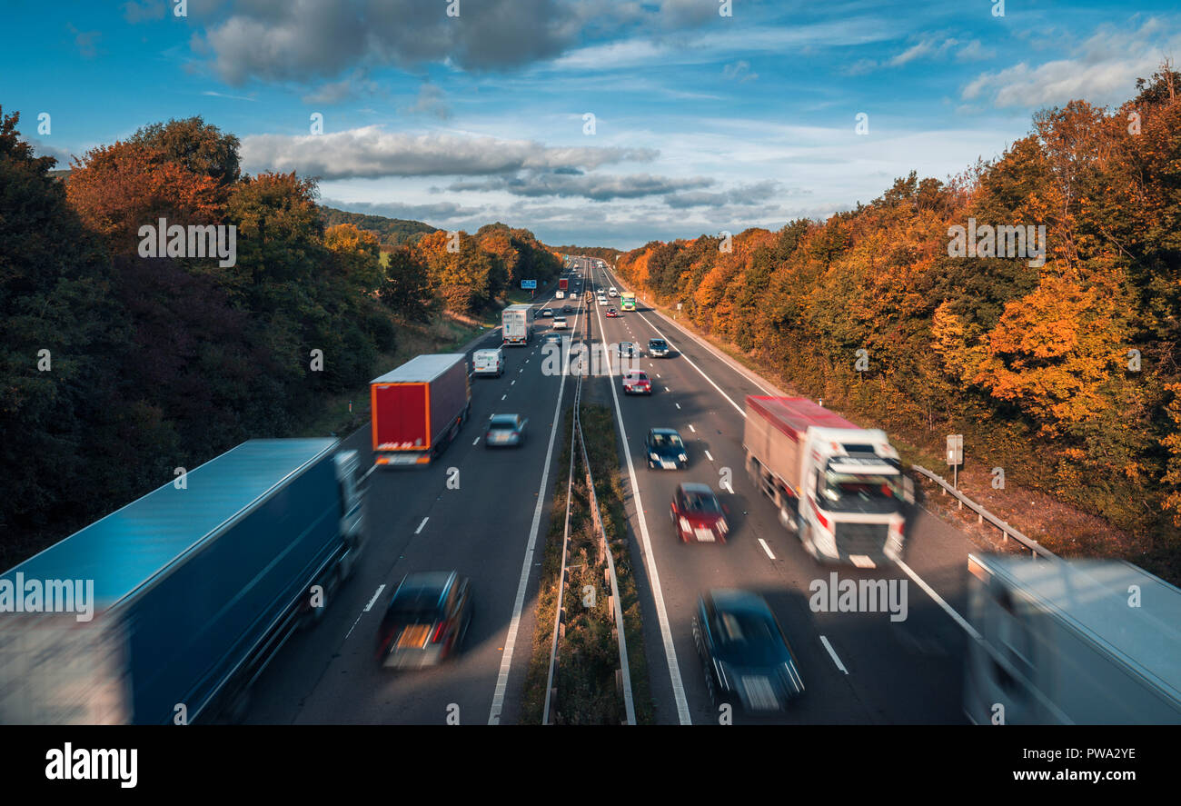 Multiple vehicles on rural motorway blurred in motion at bright sunny ...