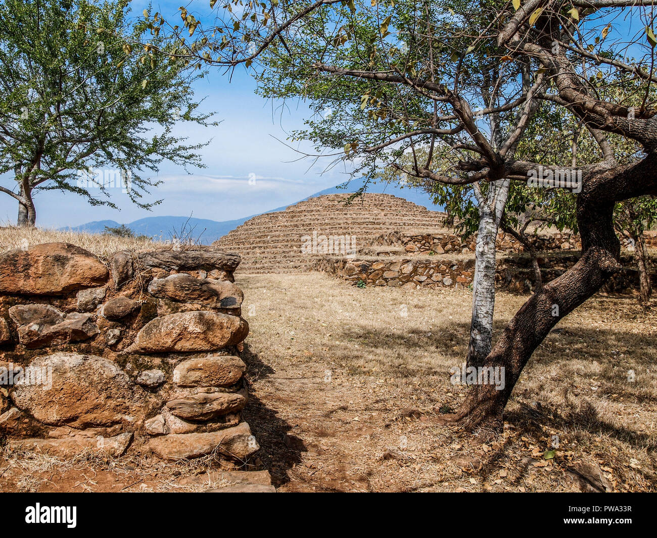 view of stone walls and a circular pyramid in the archaeological zone ...
