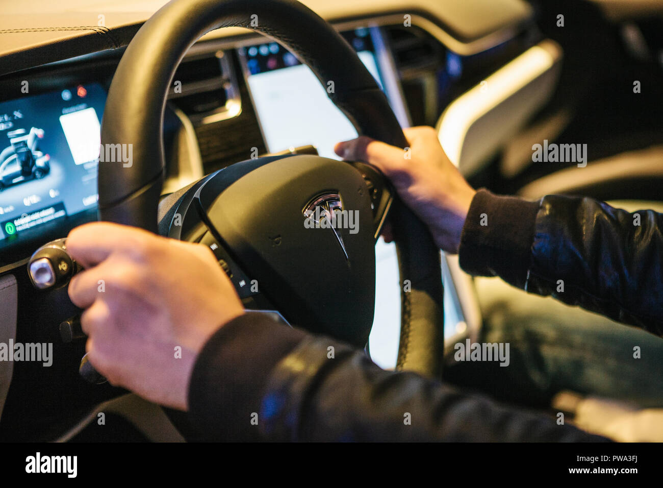 Interior of an electric car Tesla model X. The driver is driving a car ...