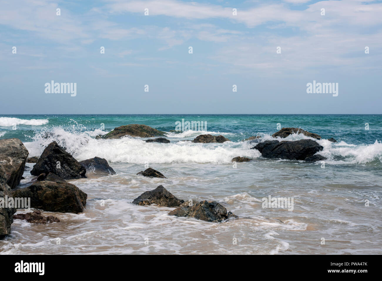 Lapping waves against rocks on a seashore in fine weather hi-res stock ...