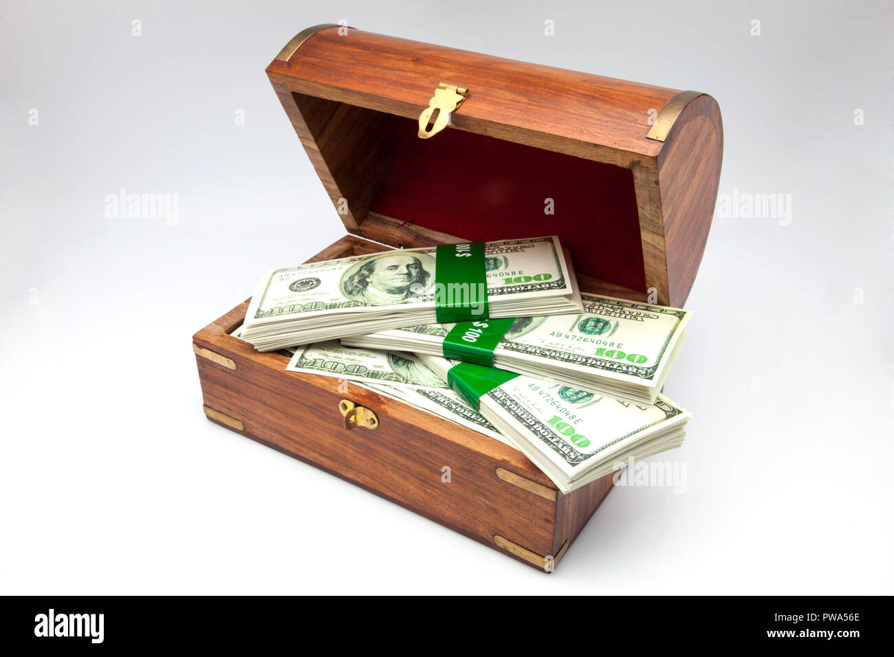 Treasure chest full of money Stock Photo - Alamy
