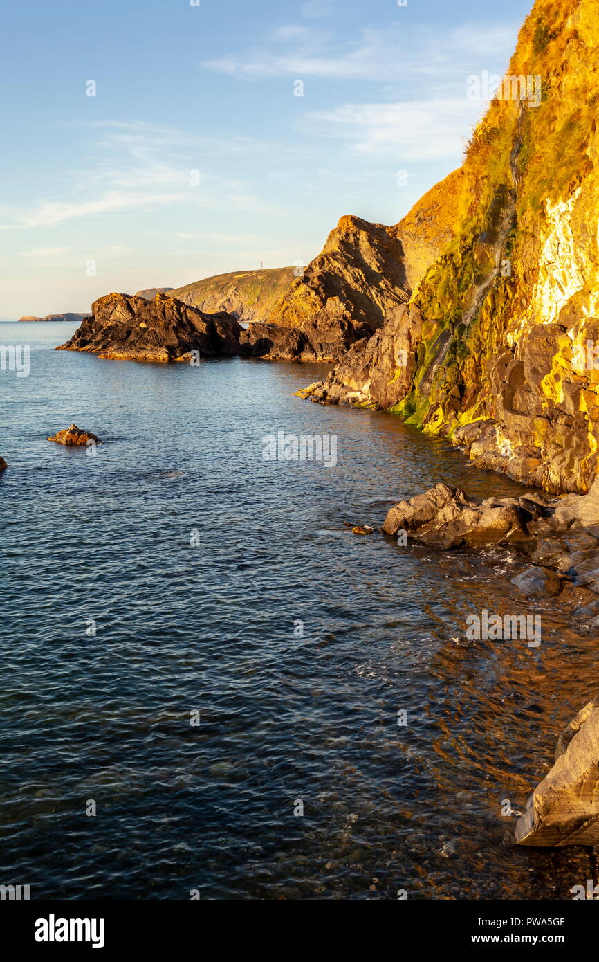 The waterfall on Tresaith beach, cascading down the cliff into the sea ...