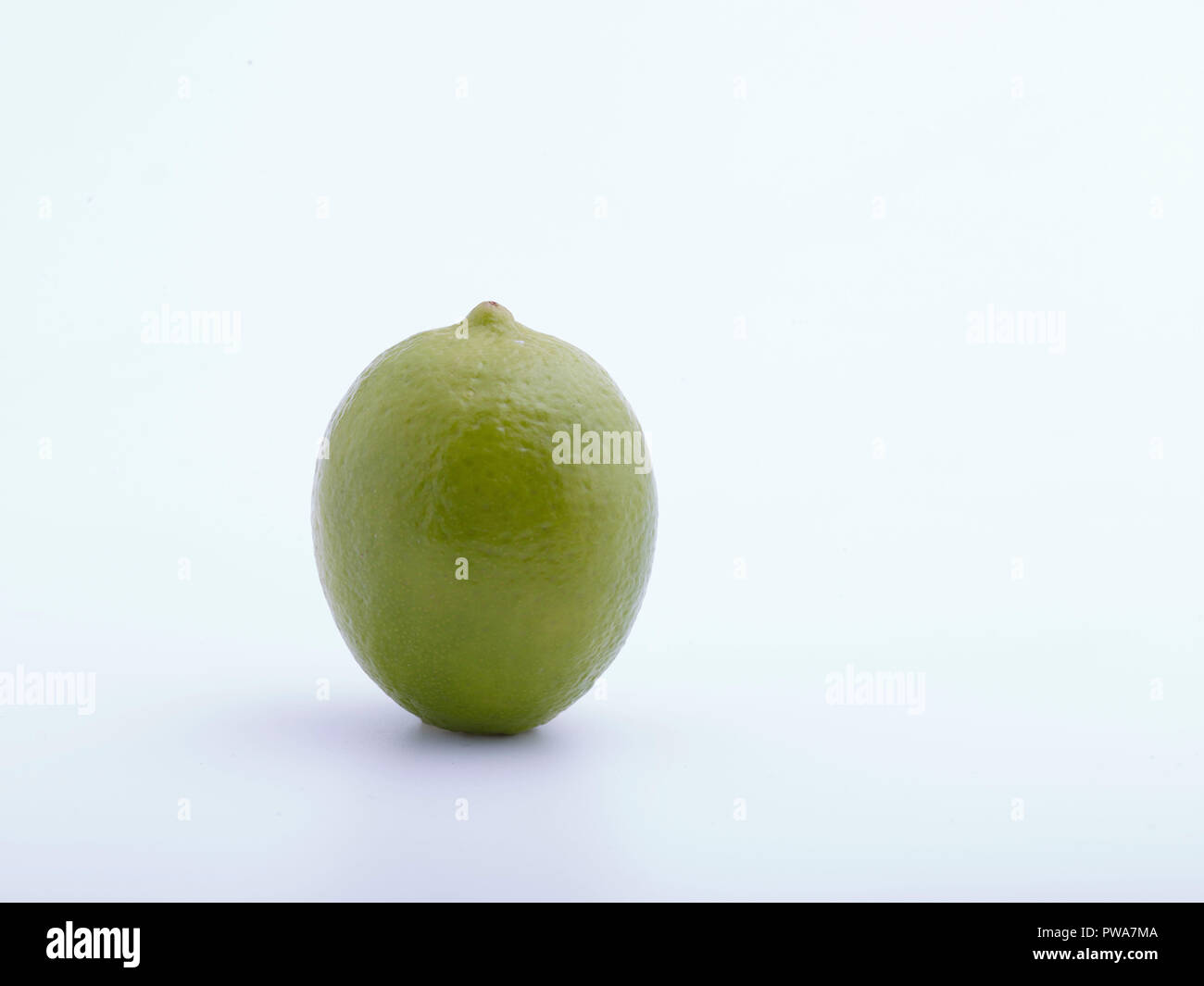 Lime food still-life on plain background Stock Photo - Alamy