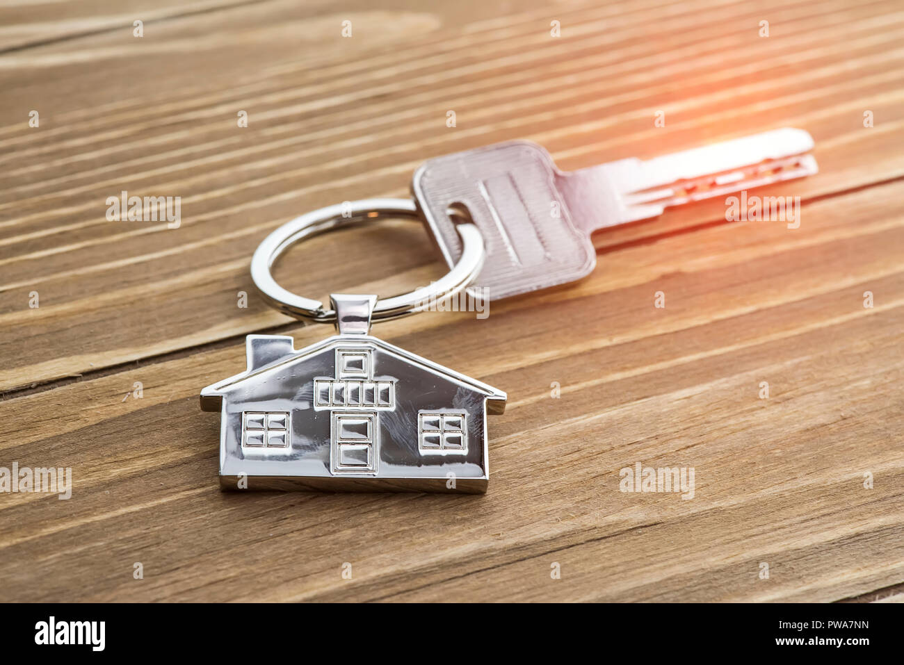 key chain with house symbol and keys on wooden background,Real estate ...