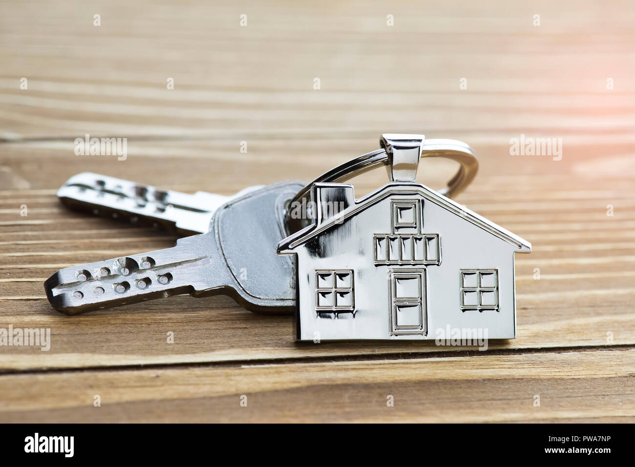 key chain with house symbol and keys on wooden background,Real estate ...