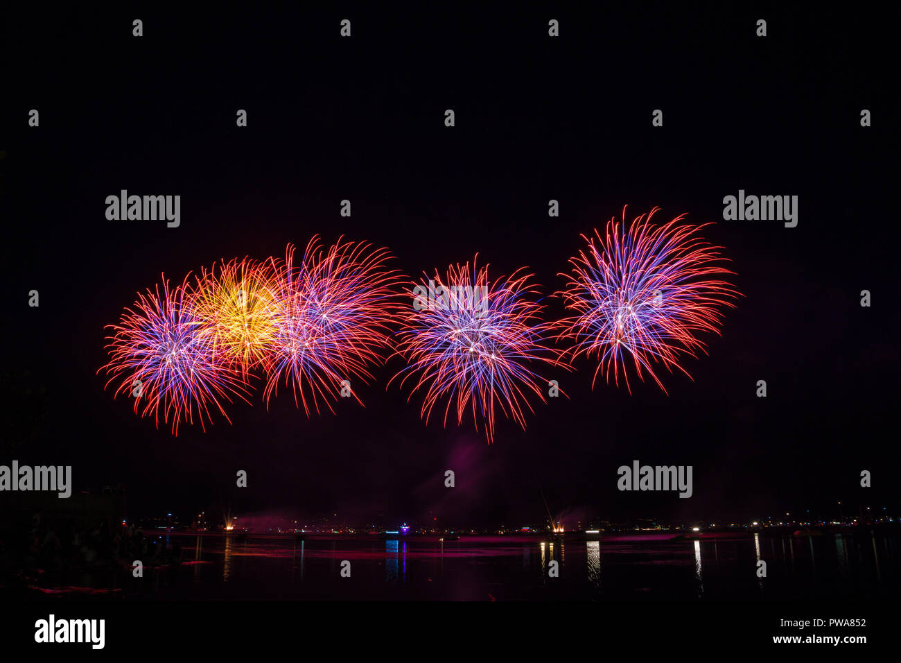 Many red fireballs of giant firework show in the night Stock Photo - Alamy