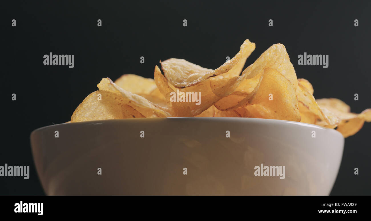 closeup potato chips in white bowl low angle shot, wide photo Stock ...