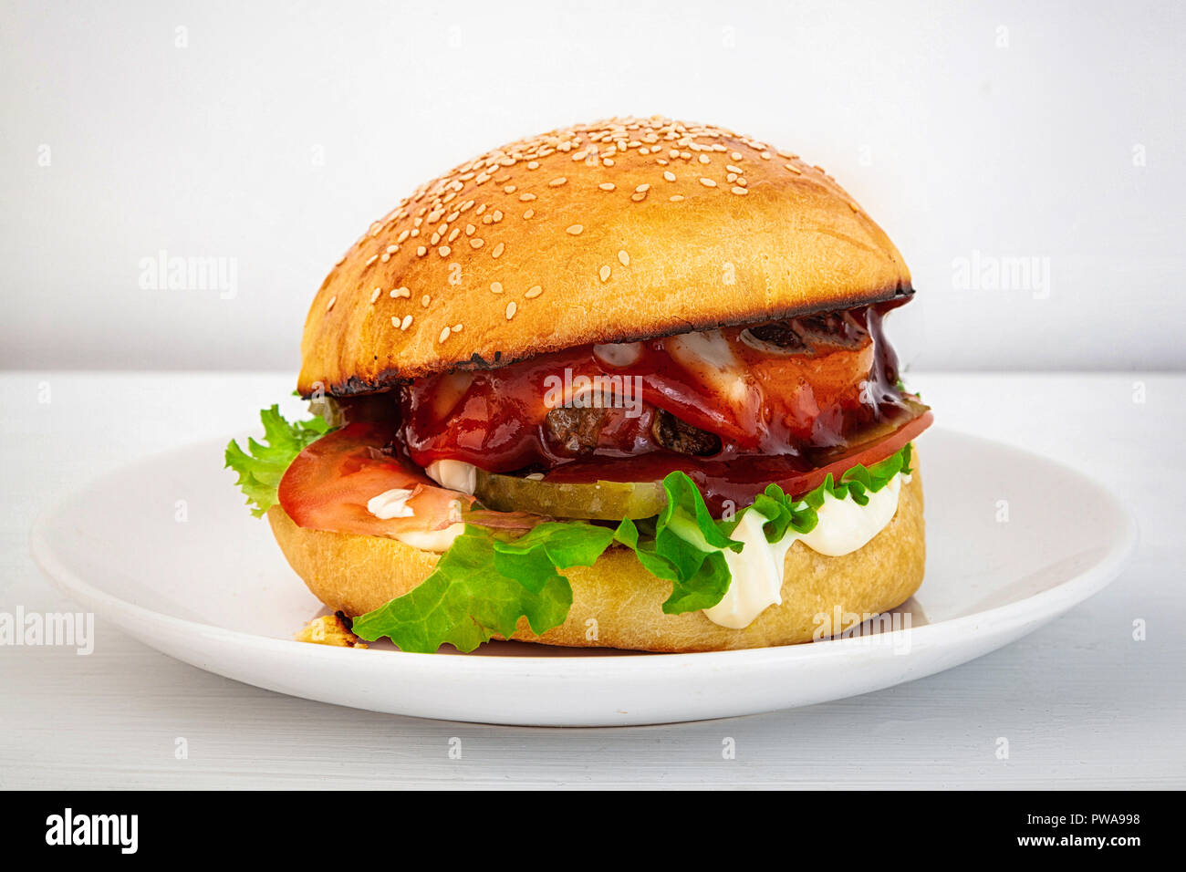Hot tasty hamburger on a plate on a white background. Homemade ...