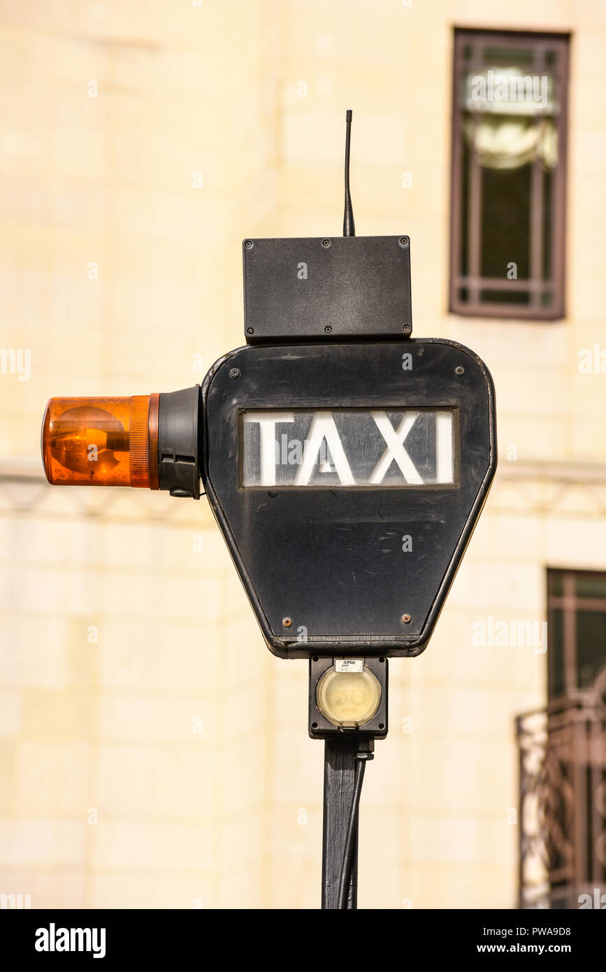 Taxi calling sign outside the Dorchester Hotel in Park Lane, London, UK ...