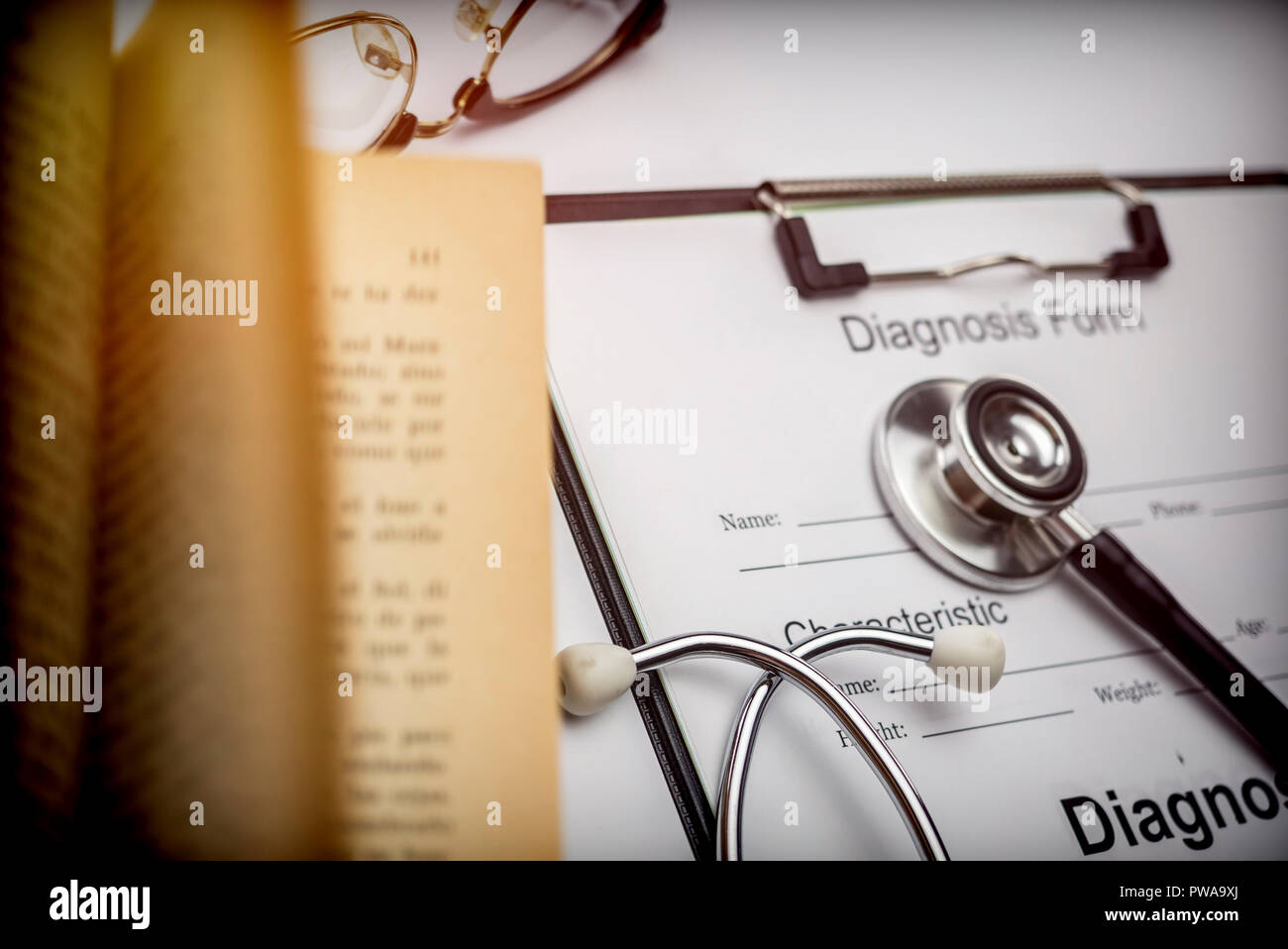Form of diagnosis next to an old workbook to a stethoscope, conceptual ...
