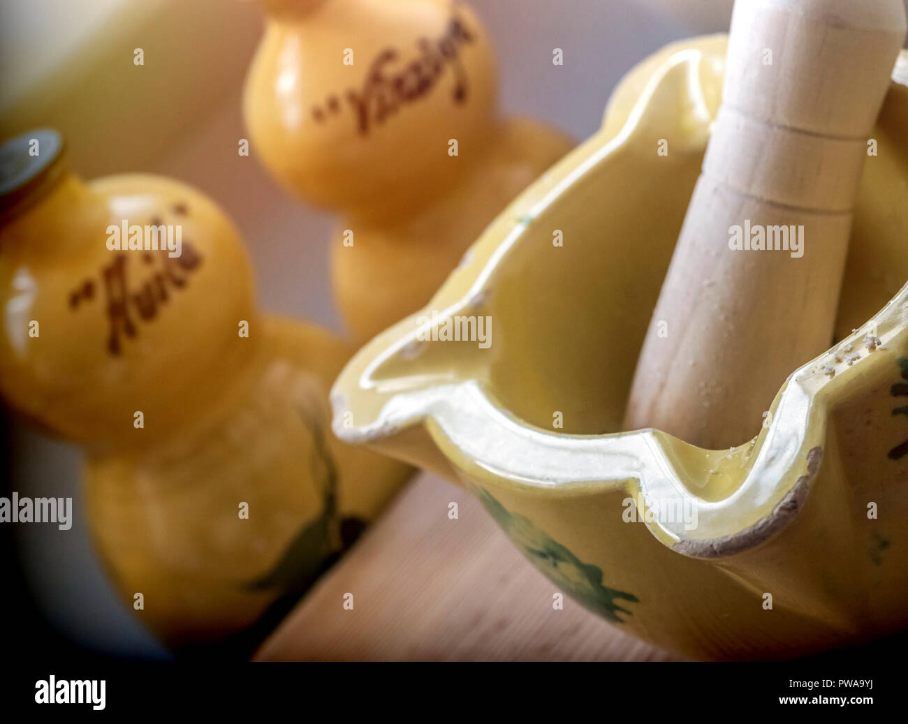 Mortar next to an oil and vinegar ceramic in a kitchen, traditional ...