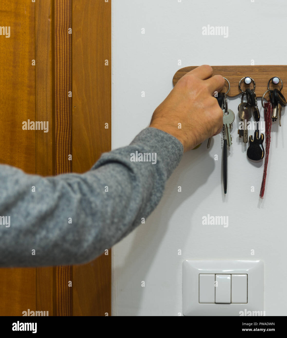 Man's hand grabbing the key Stock Photo - Alamy