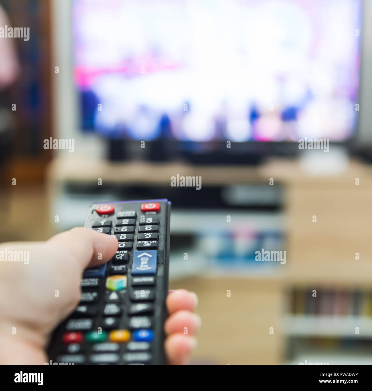 Man holding a remote control Stock Photo - Alamy