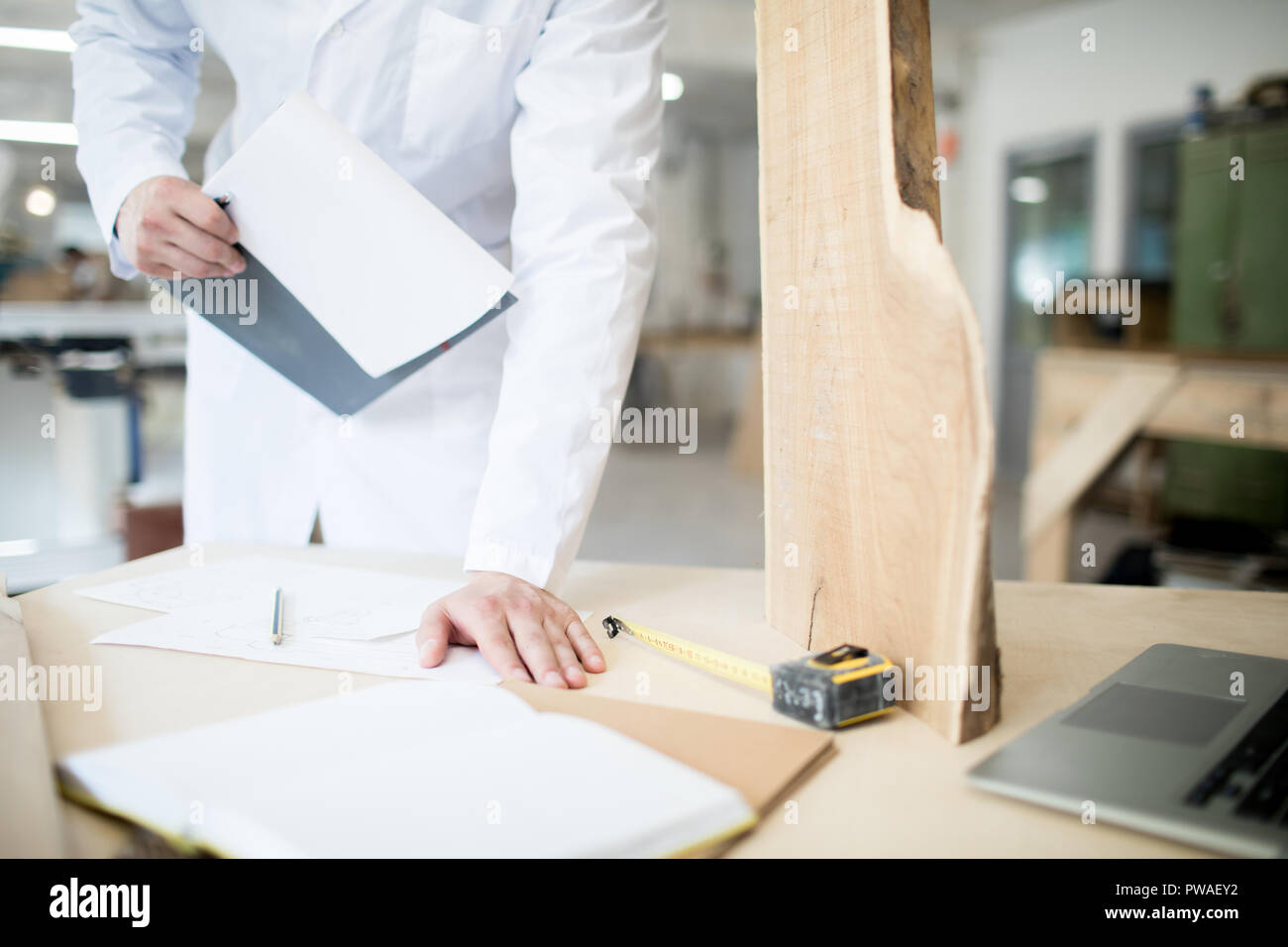 Contemporary engineer studying new material for cabinetmaking and its ...