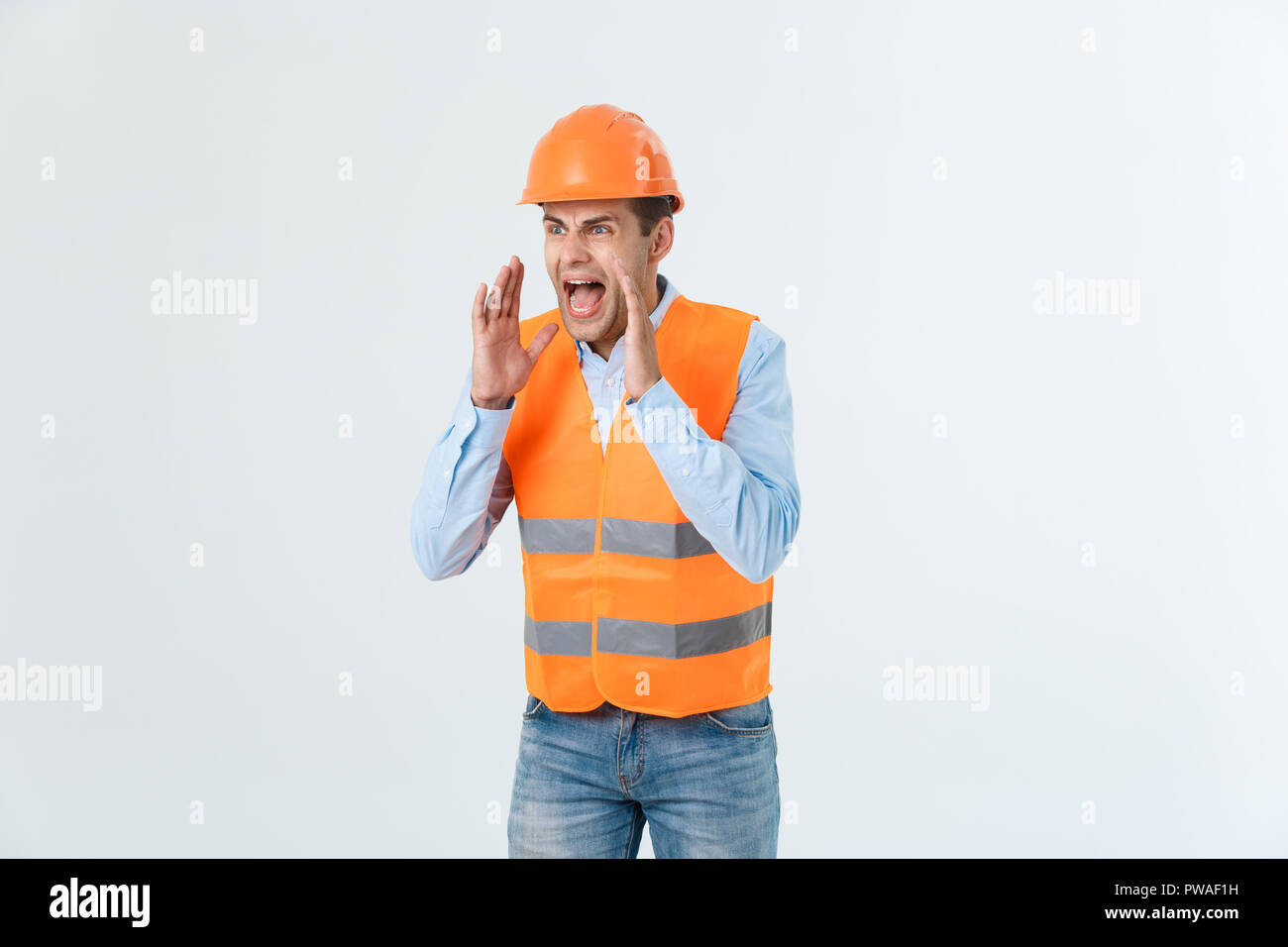 A construction worker yelling up at something Stock Photo - Alamy