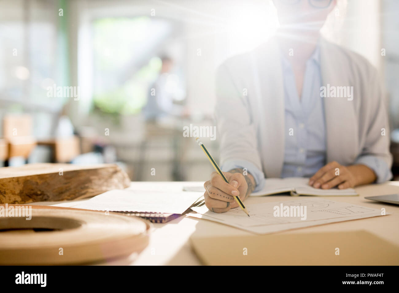 Hand of contemporary engineer with pencil over paper making technical ...