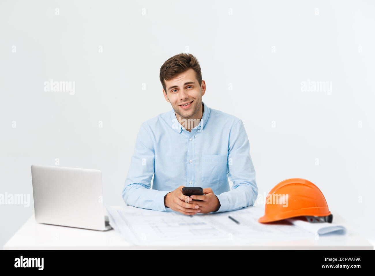 Young engineer smiling isolated on white background Stock Photo - Alamy