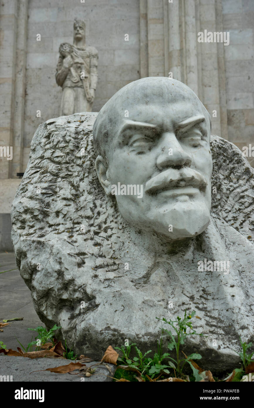 Bust of Lenin with statues of medieval monks and knights in background ...