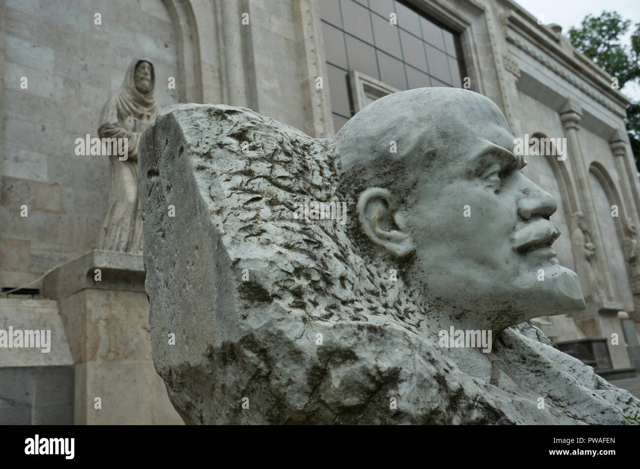 Bust of Lenin with statues of medieval monks and knights in background ...