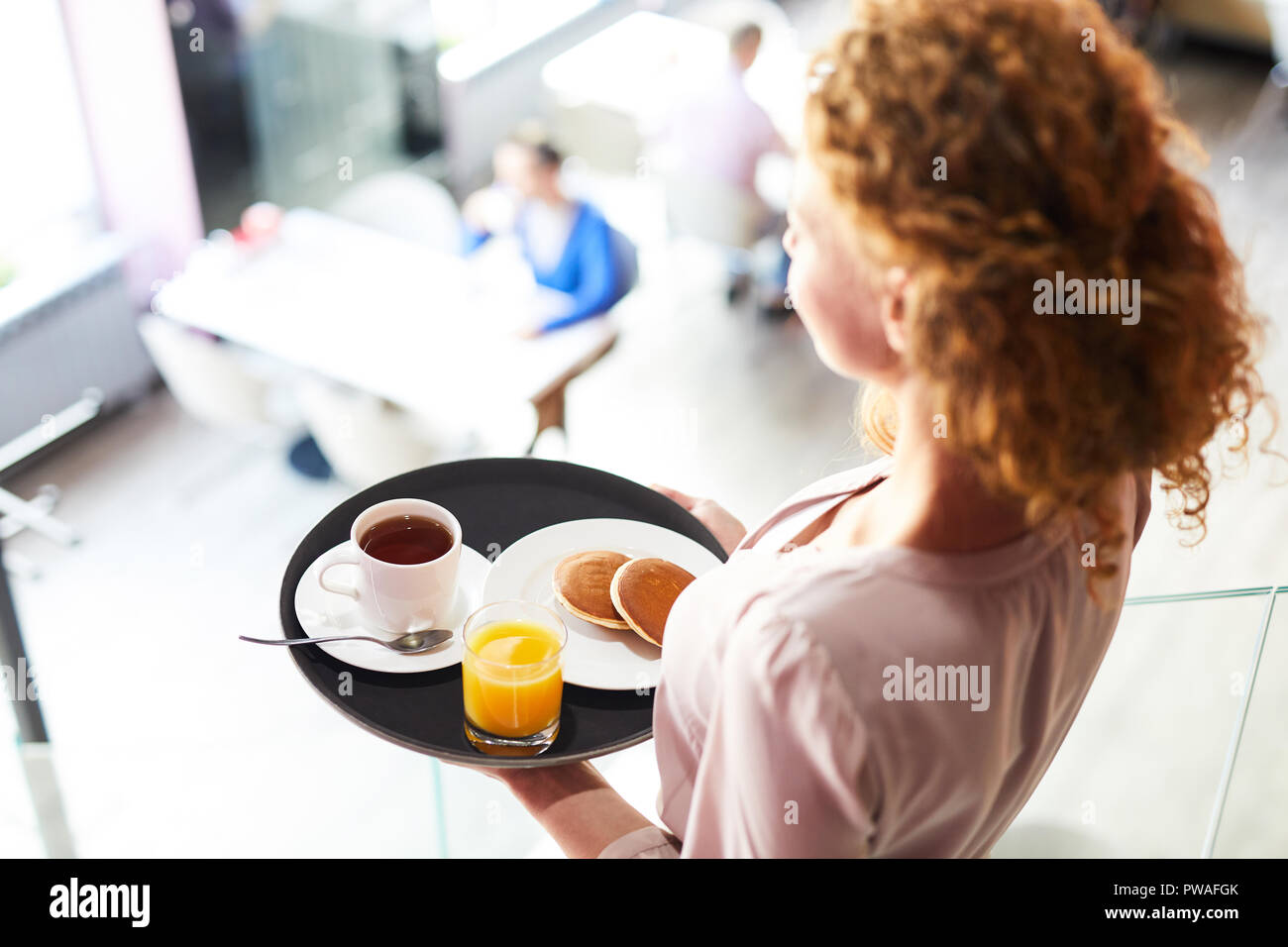 Young woman carrying tray hi-res stock photography and images - Alamy
