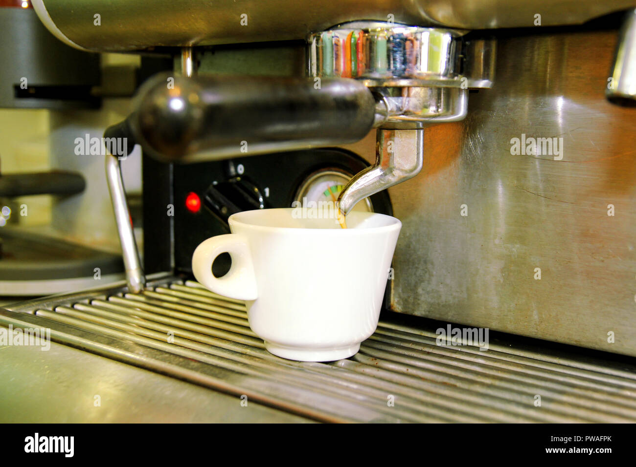 Coffee maker. Close-up white coffee cup. Espresso machine. A ...