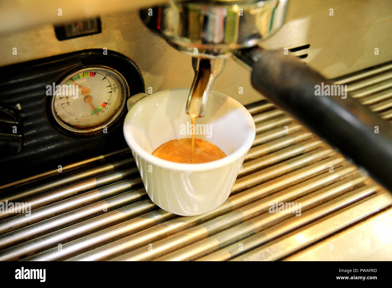 Coffee maker. Close-up white coffee cup. Espresso machine. A ...