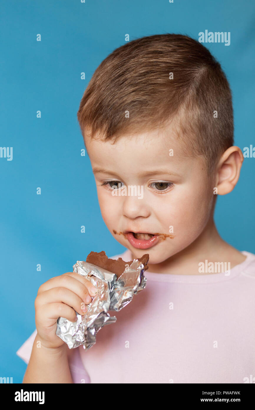 Cute Little Boy Eating Chocolate Bar. Very cute kid with chocolate ...