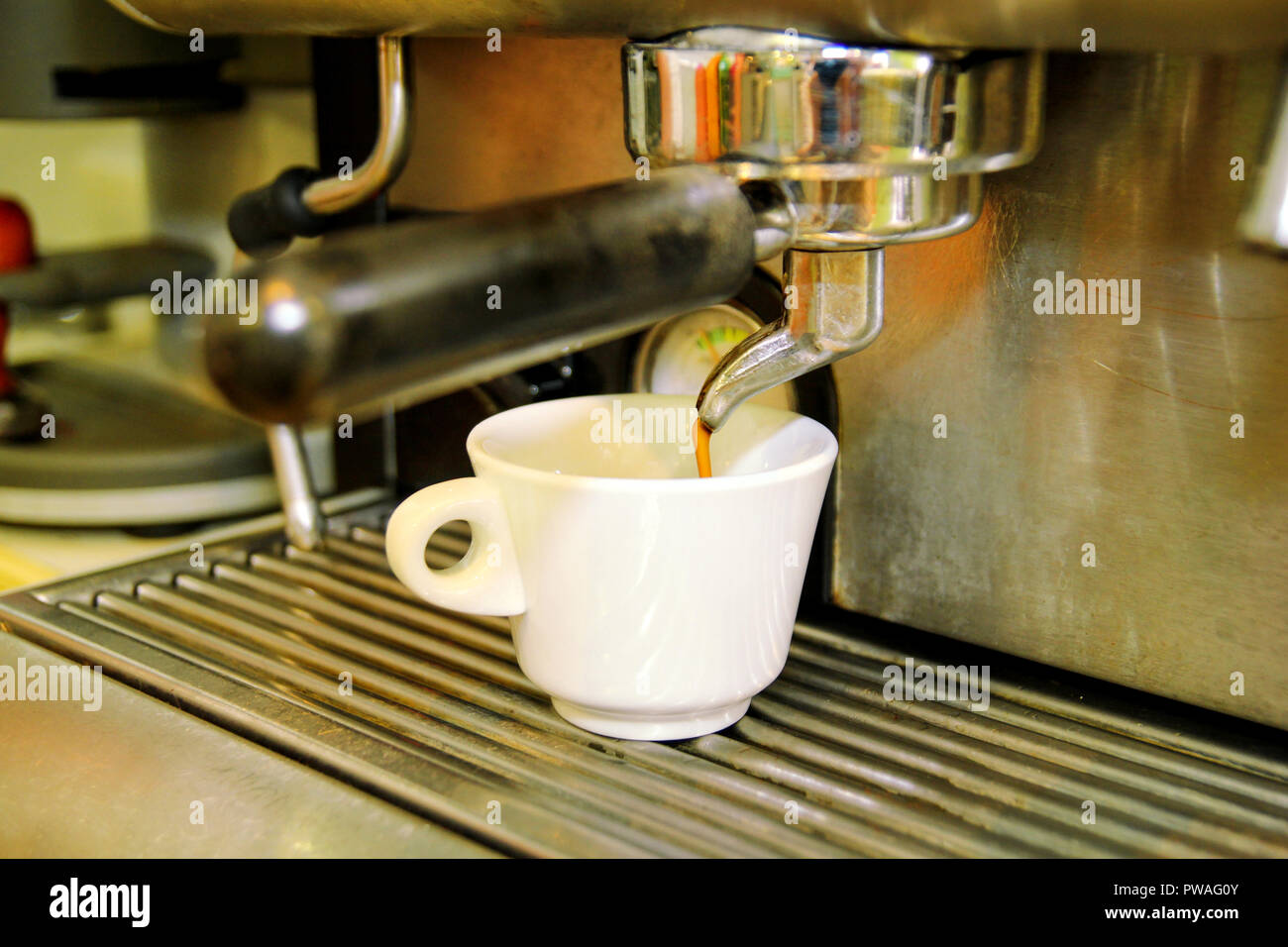 Coffee maker. Close-up white coffee cup. Espresso machine. A ...