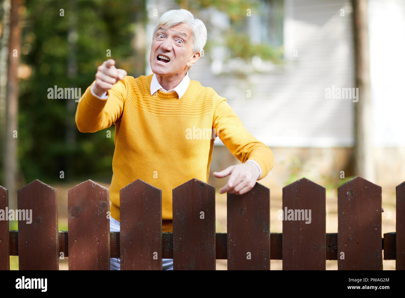 Grumpy man and fence hi-res stock photography and images - Alamy