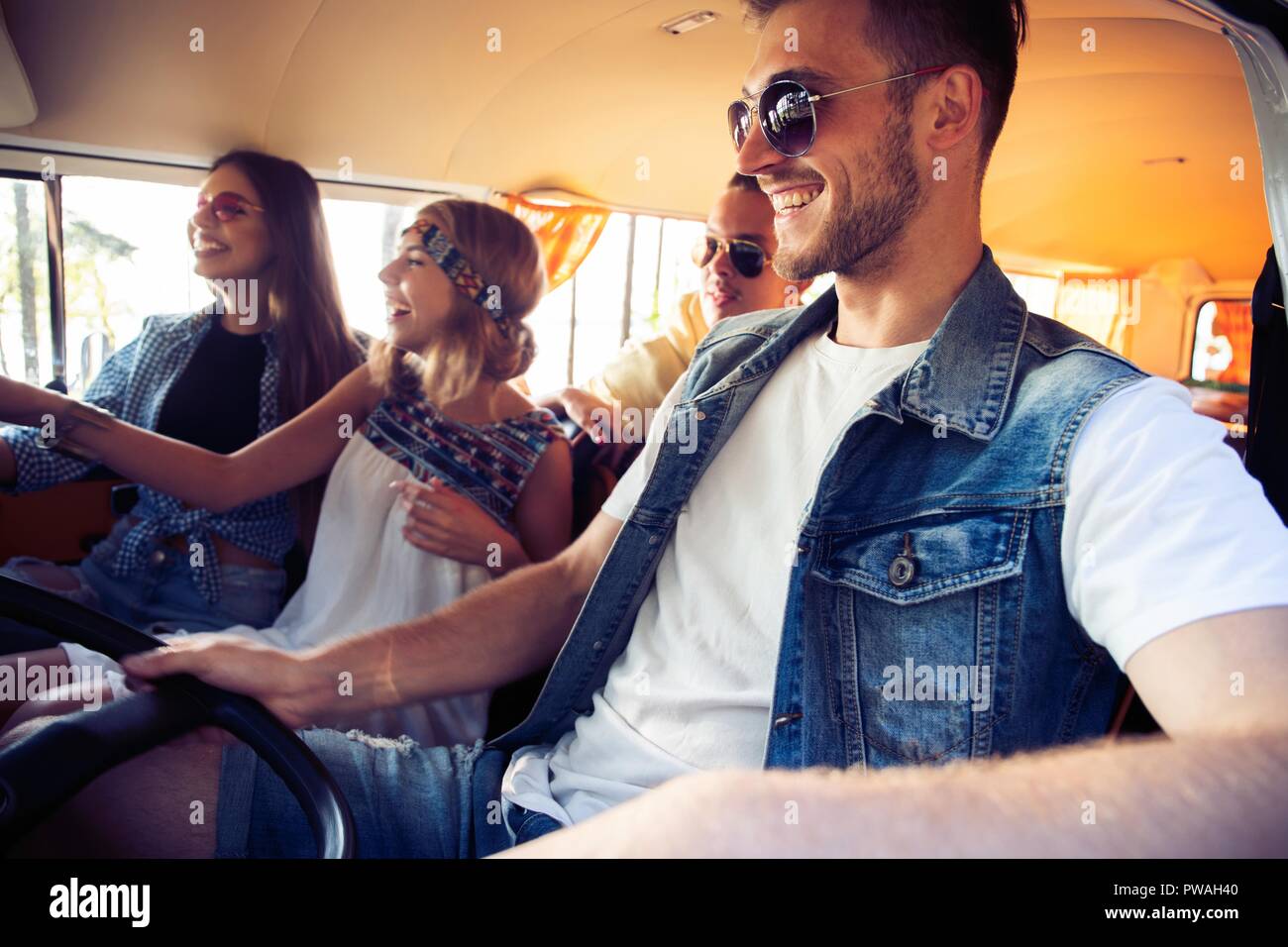 Enjoying great roadtrip with friends. Group of cheerful young people ...