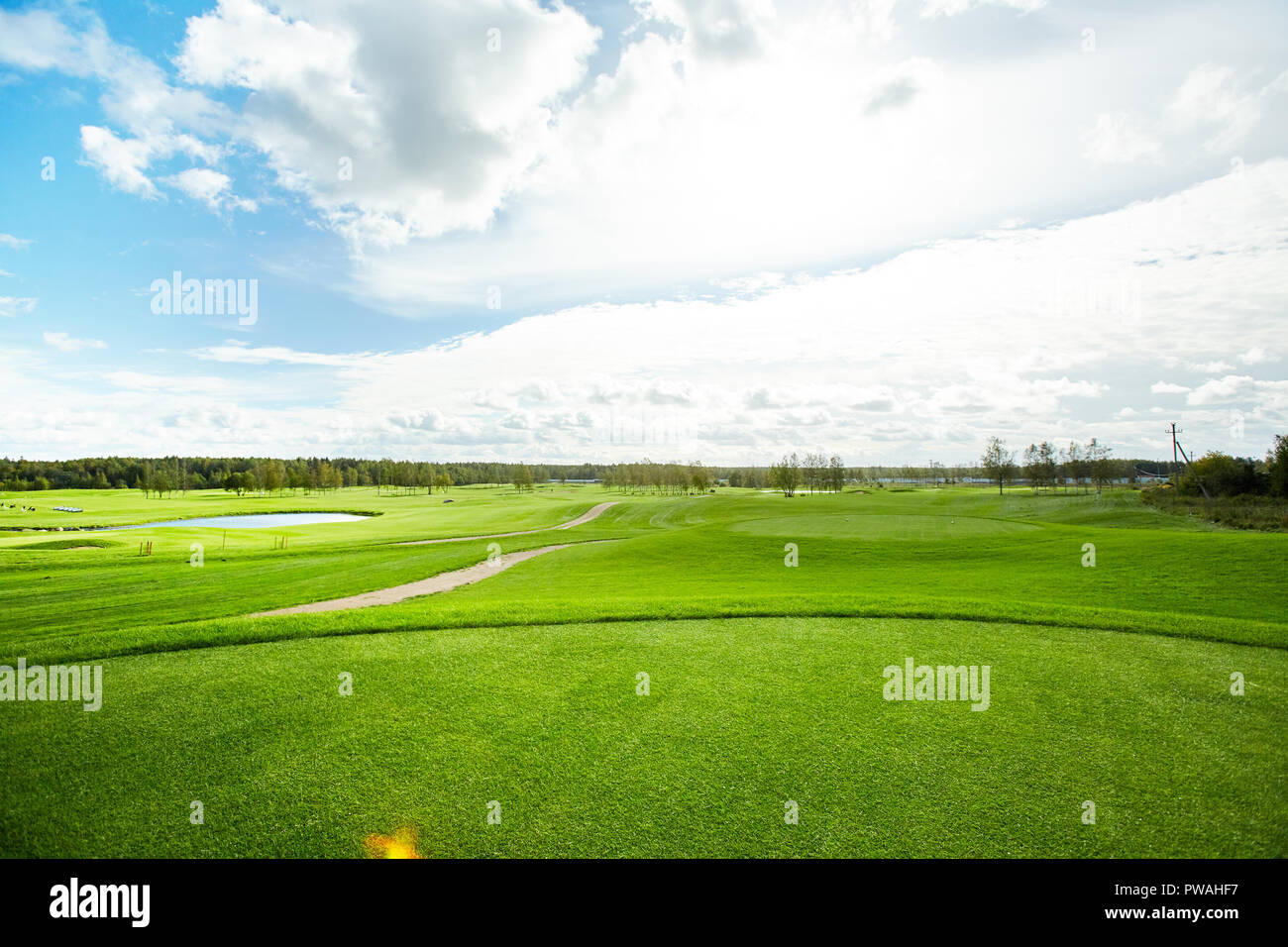 Rural environment with vast green field or valley, pathways, river and ...