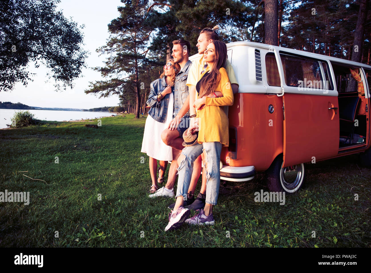 Cheerful young couple enjoying time together while leaning at their ...
