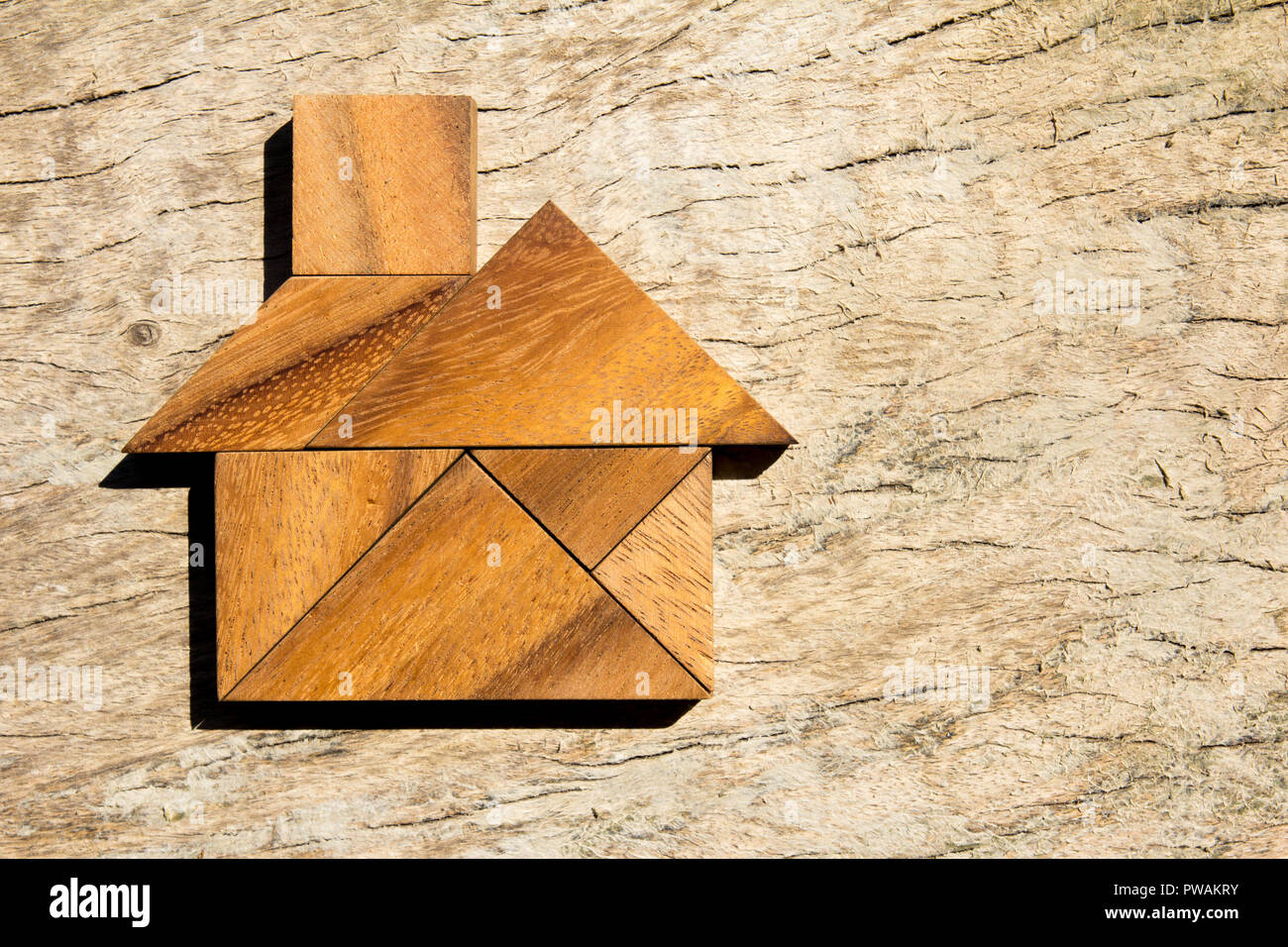 Wooden tangram puzzle in home shape for dream home or happy life ...
