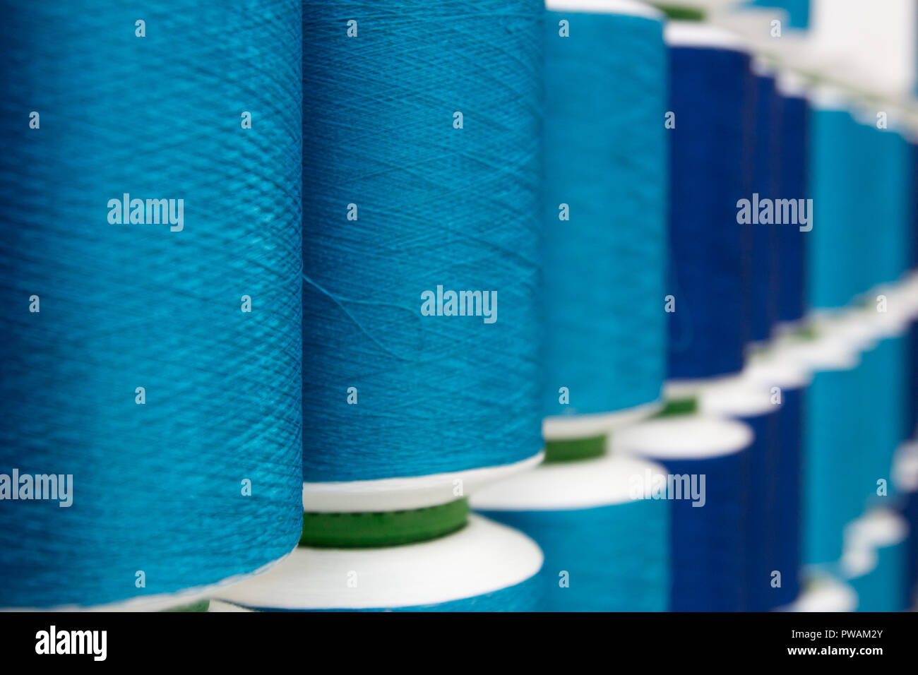 Closed up of vairous blue color thread reel background Stock Photo - Alamy